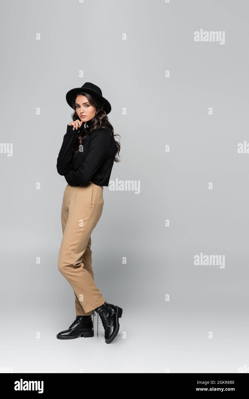 full length of pretty young model in black fedora hat and stylish ...