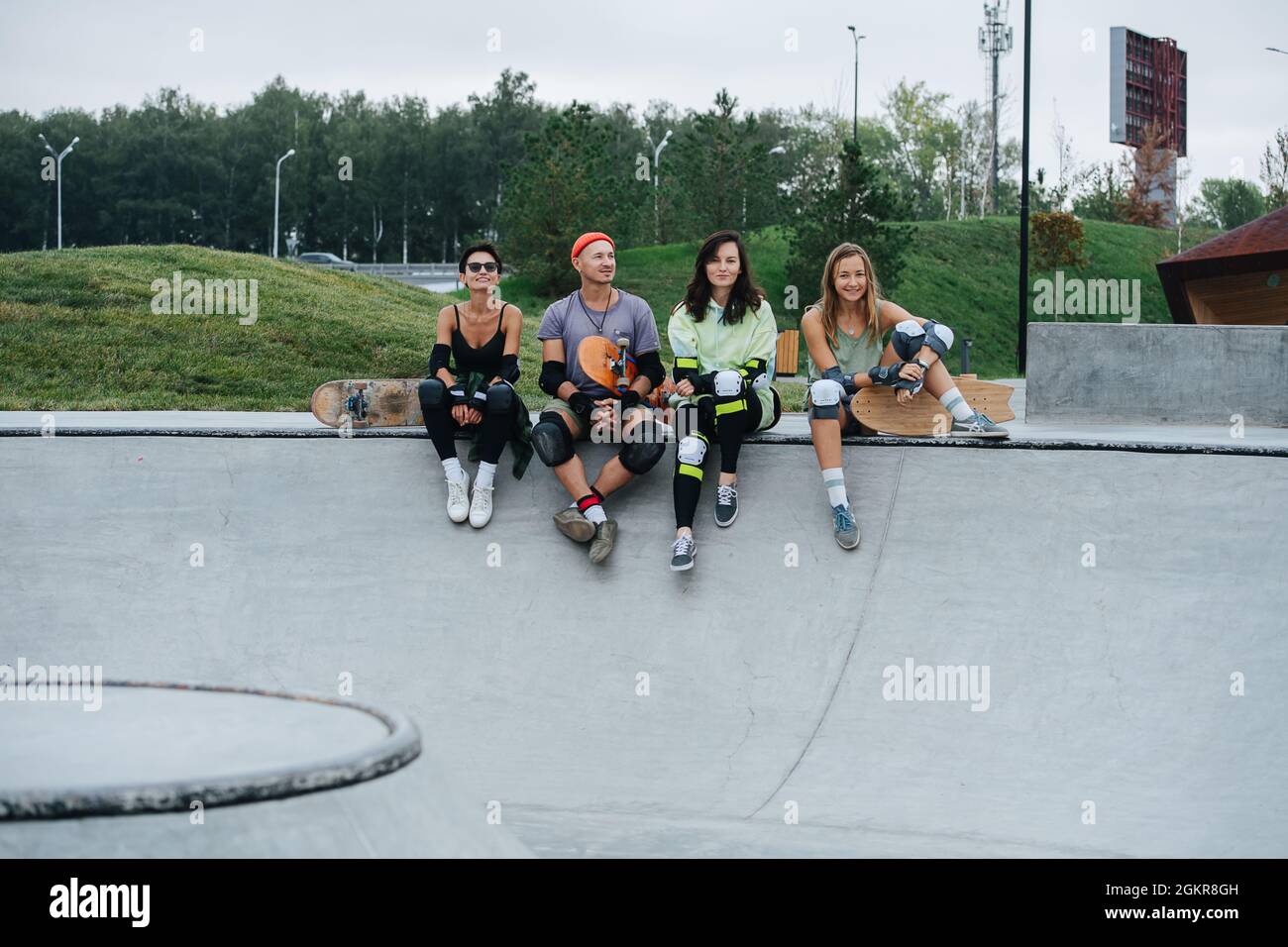 Longshot portrait of a group of skaters chilling on the deck at ...