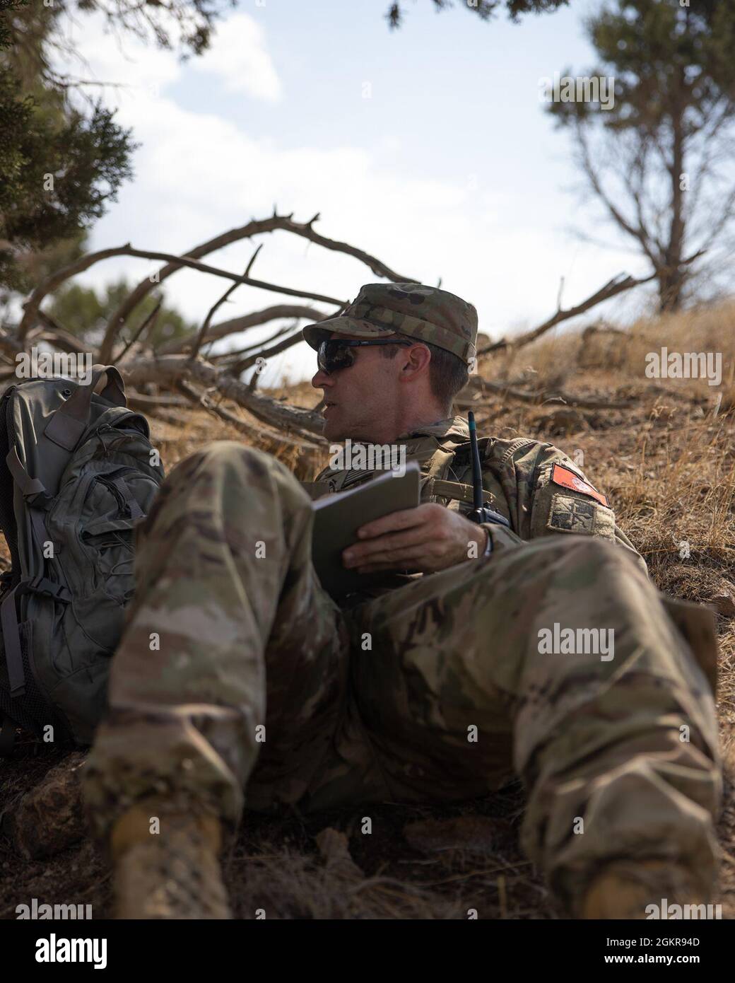 A Panther Strike participant conceals himself in a treeline with his ...