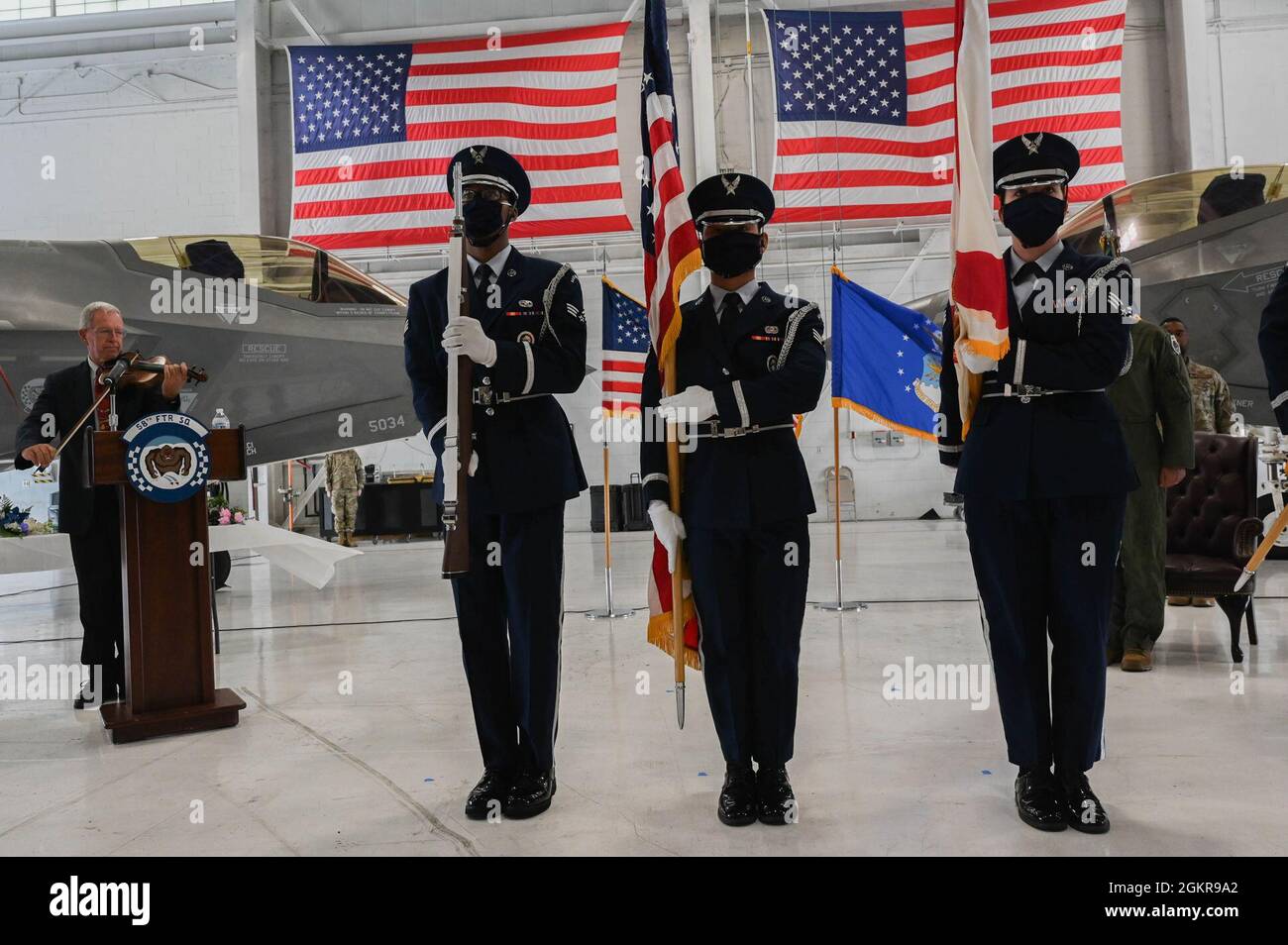 U.S. Air Force Team Eglin Honor Guard presents the colors while John ...