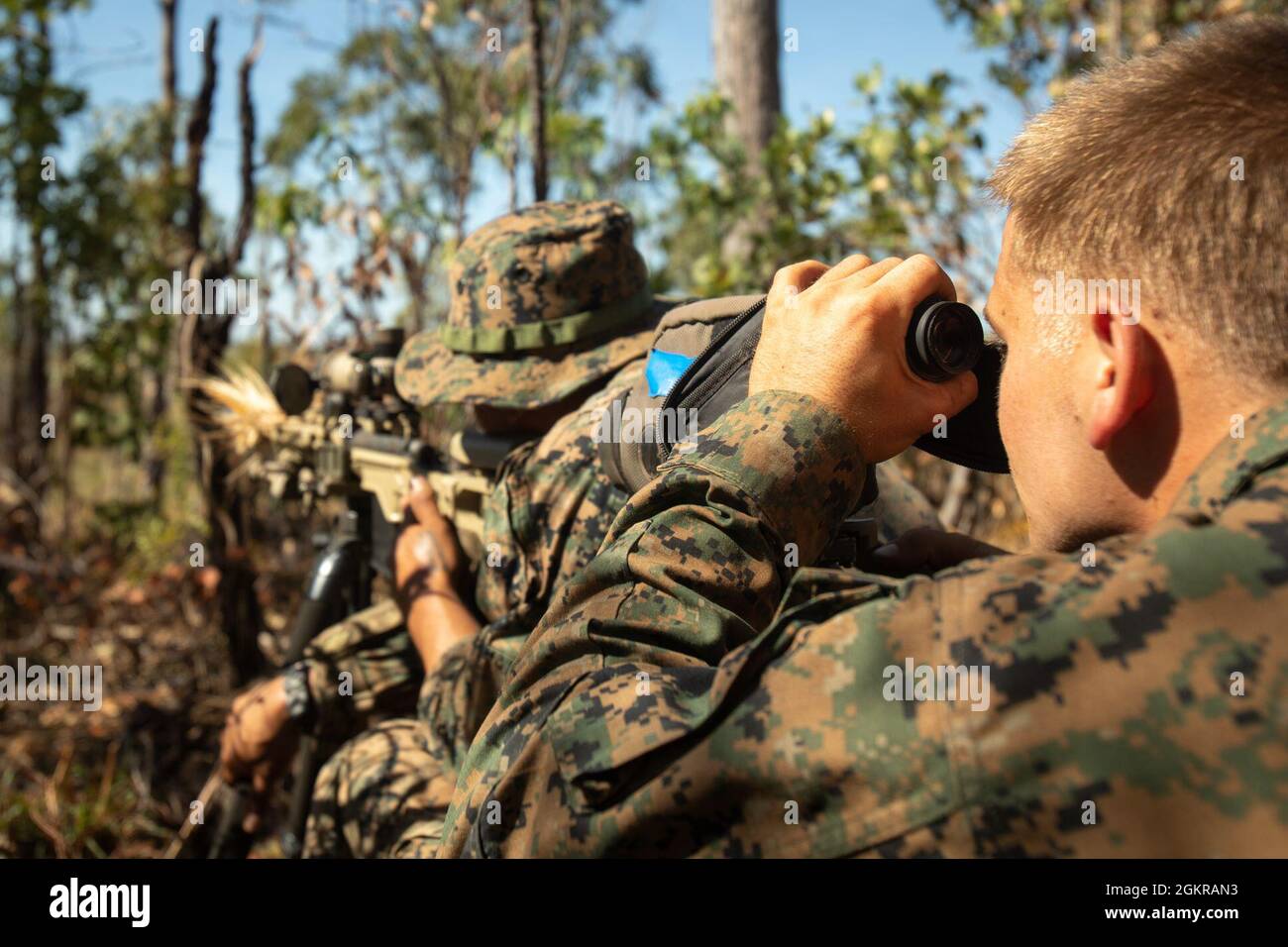 U.S. Navy Hospitalman Sean Carney, right, sights in on a target for ...