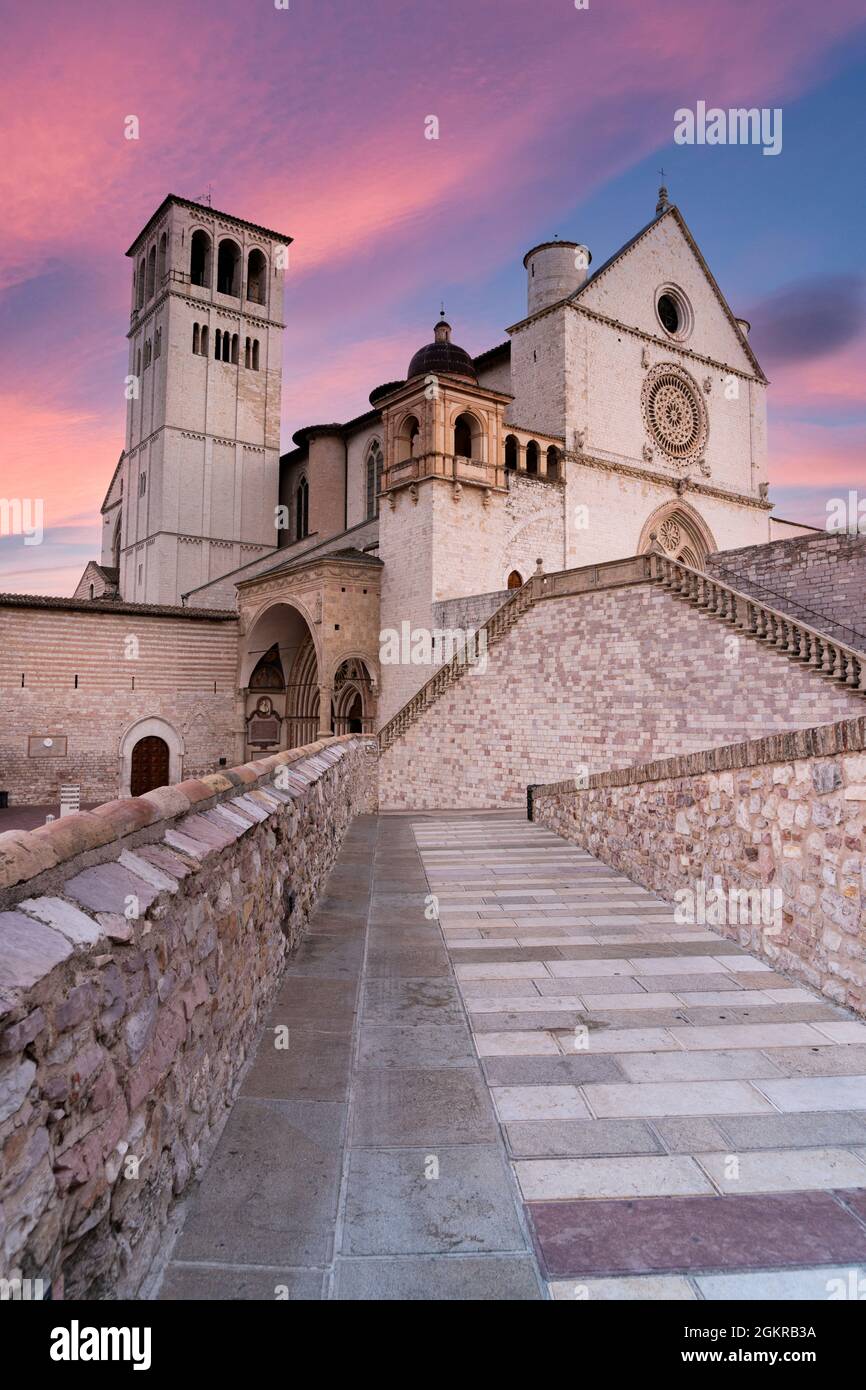 Pink sunrise over the Papal Basilica of Saint Francis in Assisi, UNESCO ...
