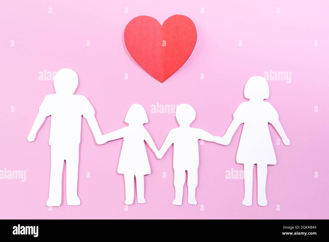 Paper family cut out on bright pink background with paper heart. Family ...