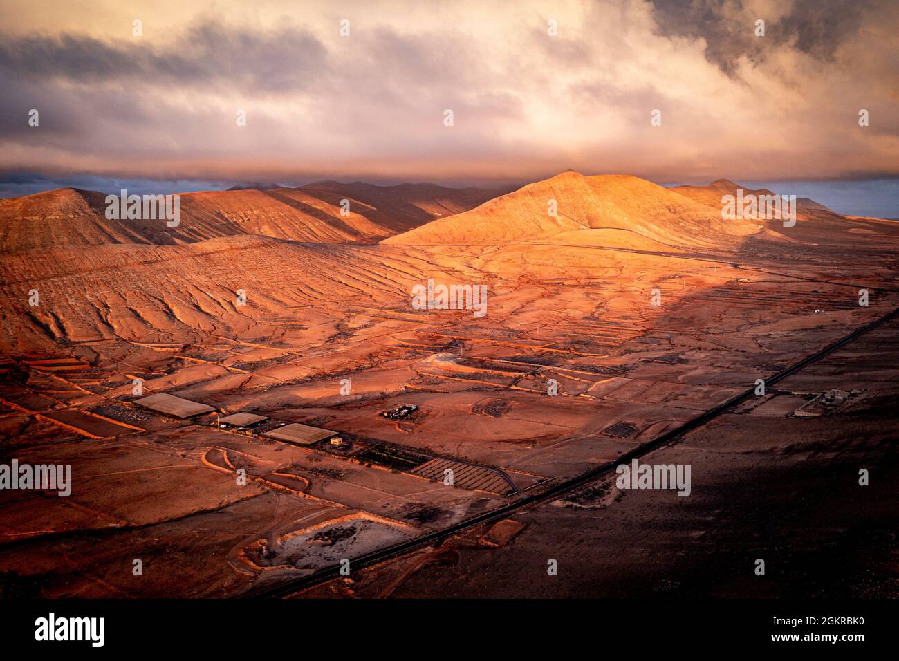 Aerial view of sunrise over the dry desert land of Caldereta, Vallebron ...