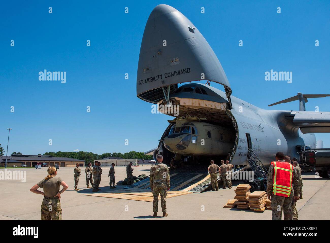 A U.S. Army CH-47F Chinook is removed from the cargo area of a U.S. Air ...
