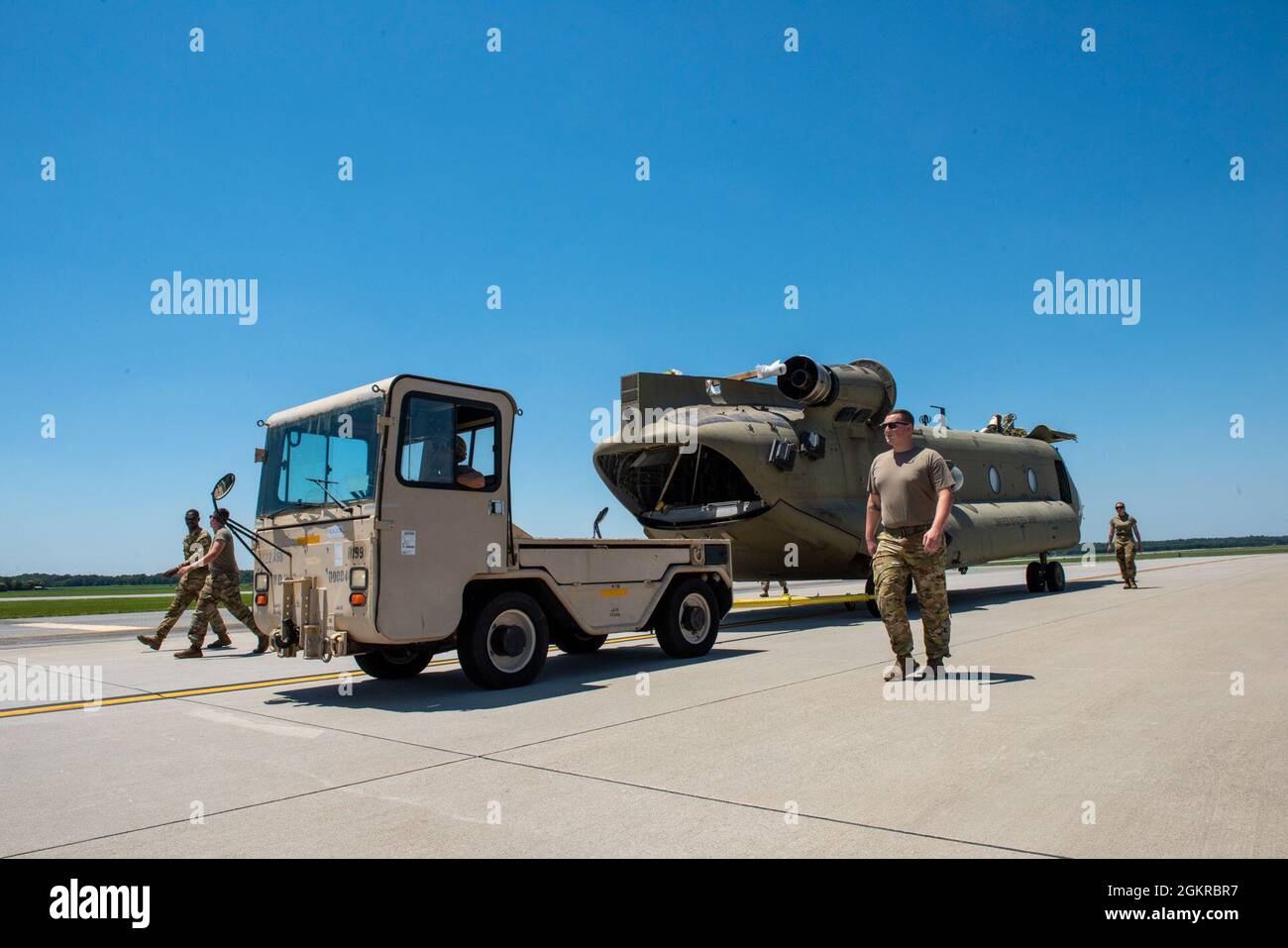 U.S. Army maintainers transport a CH-47F Chinook to a hangar to be ...