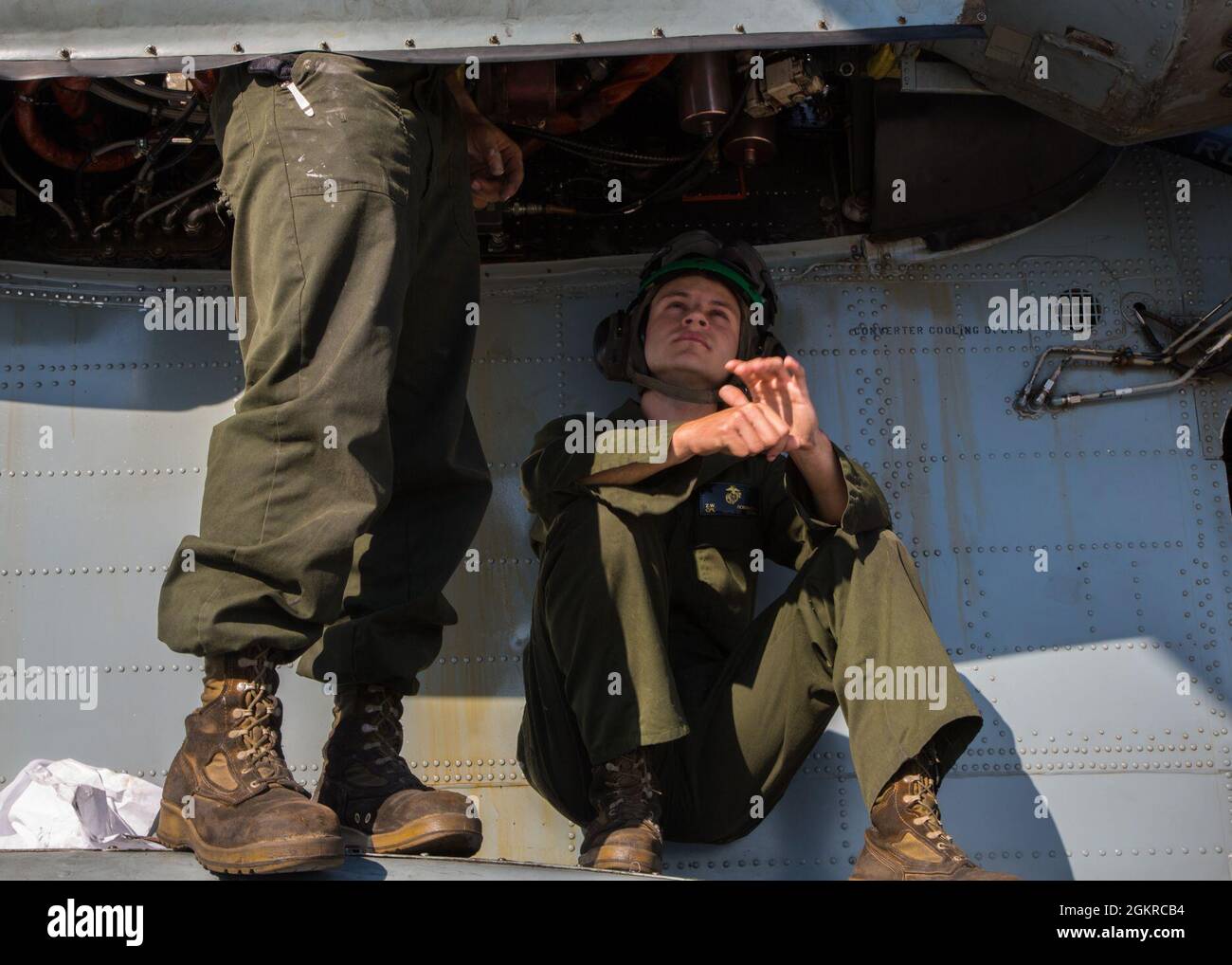 U.S. Marine Corps Cpl. John Griffith, and Cpl. Zane Robinson, CH-53E aircraft maintainers ...