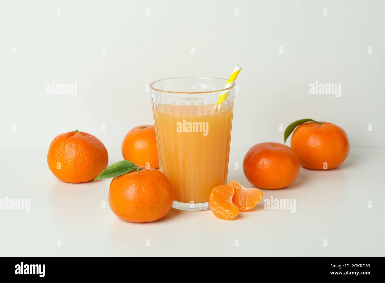 Glass of mandarin juice and ingredients on white background Stock Photo ...
