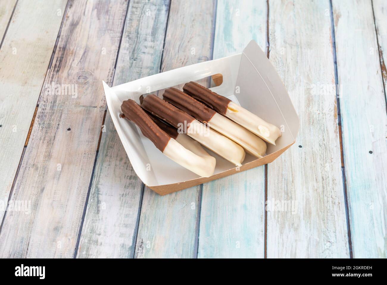 Churros ration with two chocolates on a home delivery container Stock ...