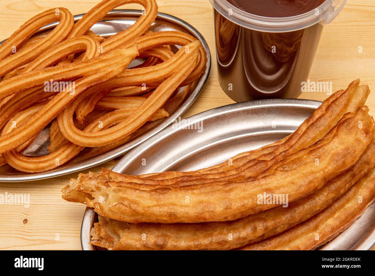 Madrid-style churros and porras on metal trays and hot chocolate Stock ...