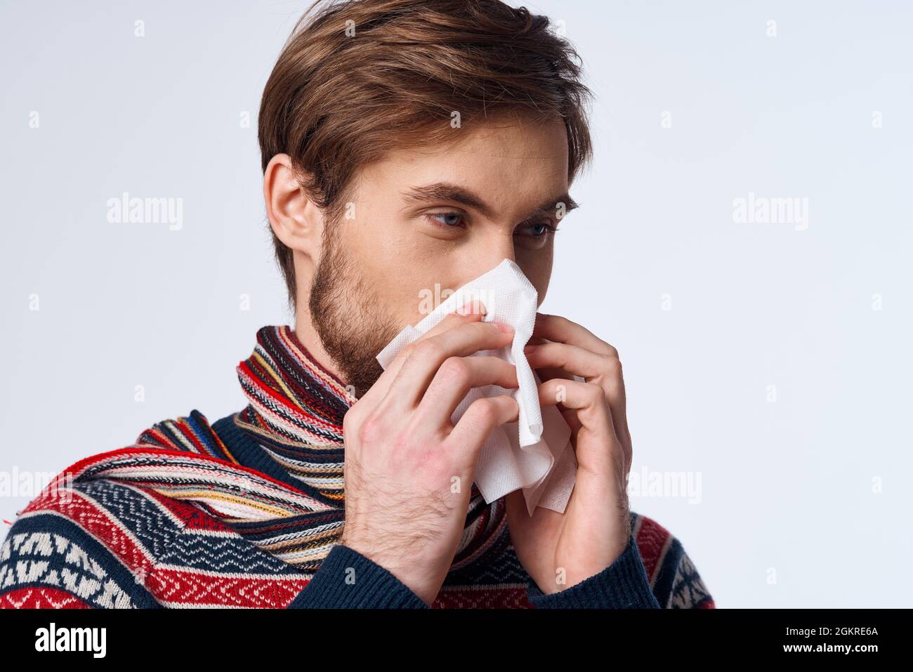 emotional man wiping his nose with a handkerchief infection virus light ...