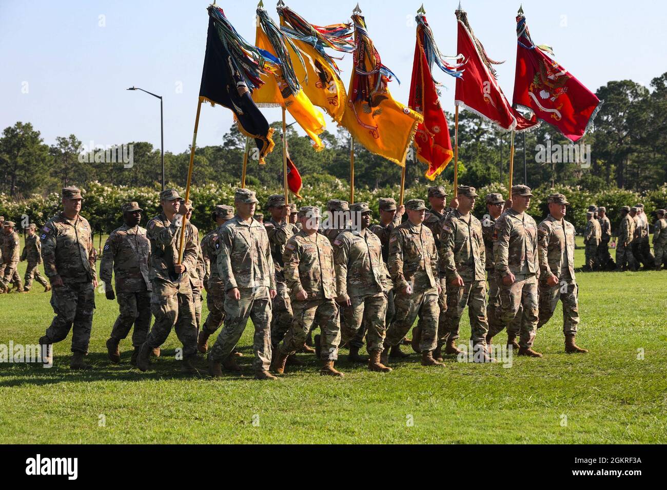 Dogface Soldiers march with their unit colors for pass and review ...