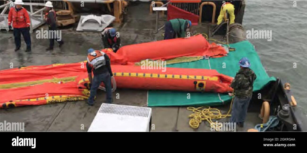 Coast Guard personnel deploying a Navy current buster system (CBS) from ...