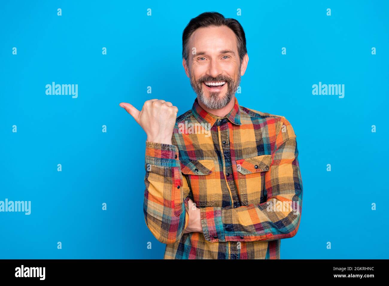Photo portrait man smiling happy wearing checkered shirt showing thumb ...