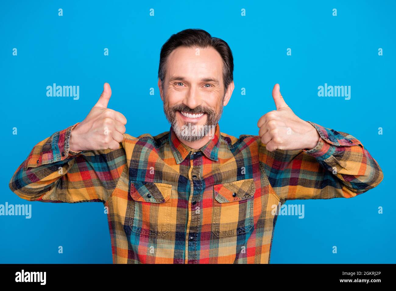 Photo portrait man smiling showing like sign recommend isolated vibrant ...