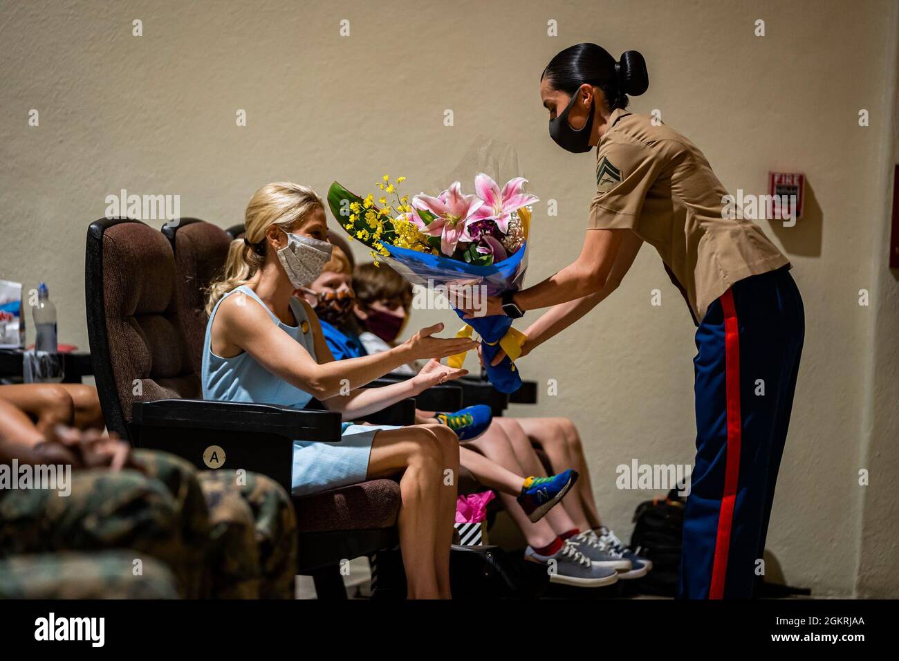 Flowers are presented to U.S. Marine Corps Lt. Col. Anthony D. Ramey’s ...