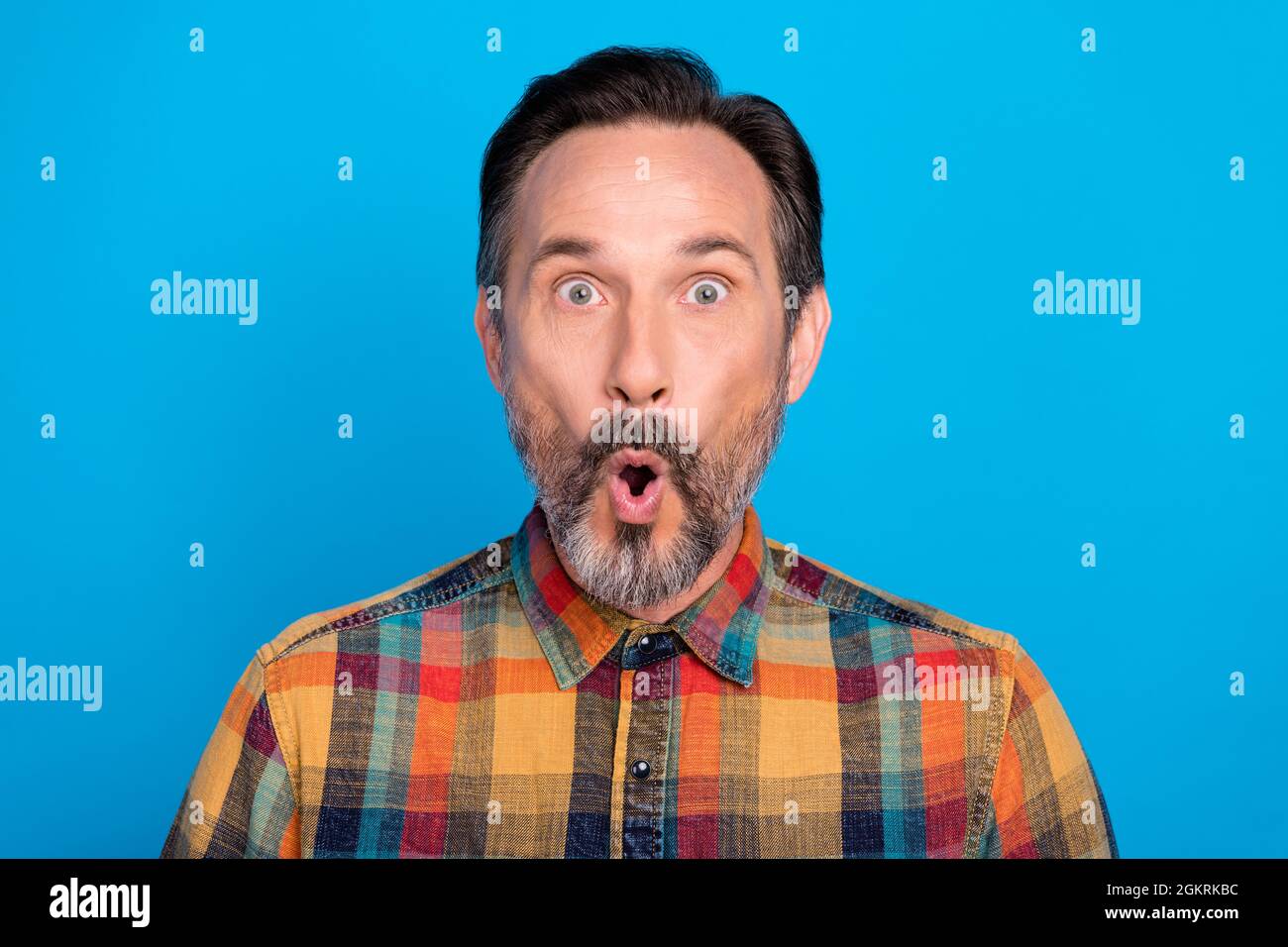Photo portrait man staring amazed in plaid shirt isolated bright blue ...
