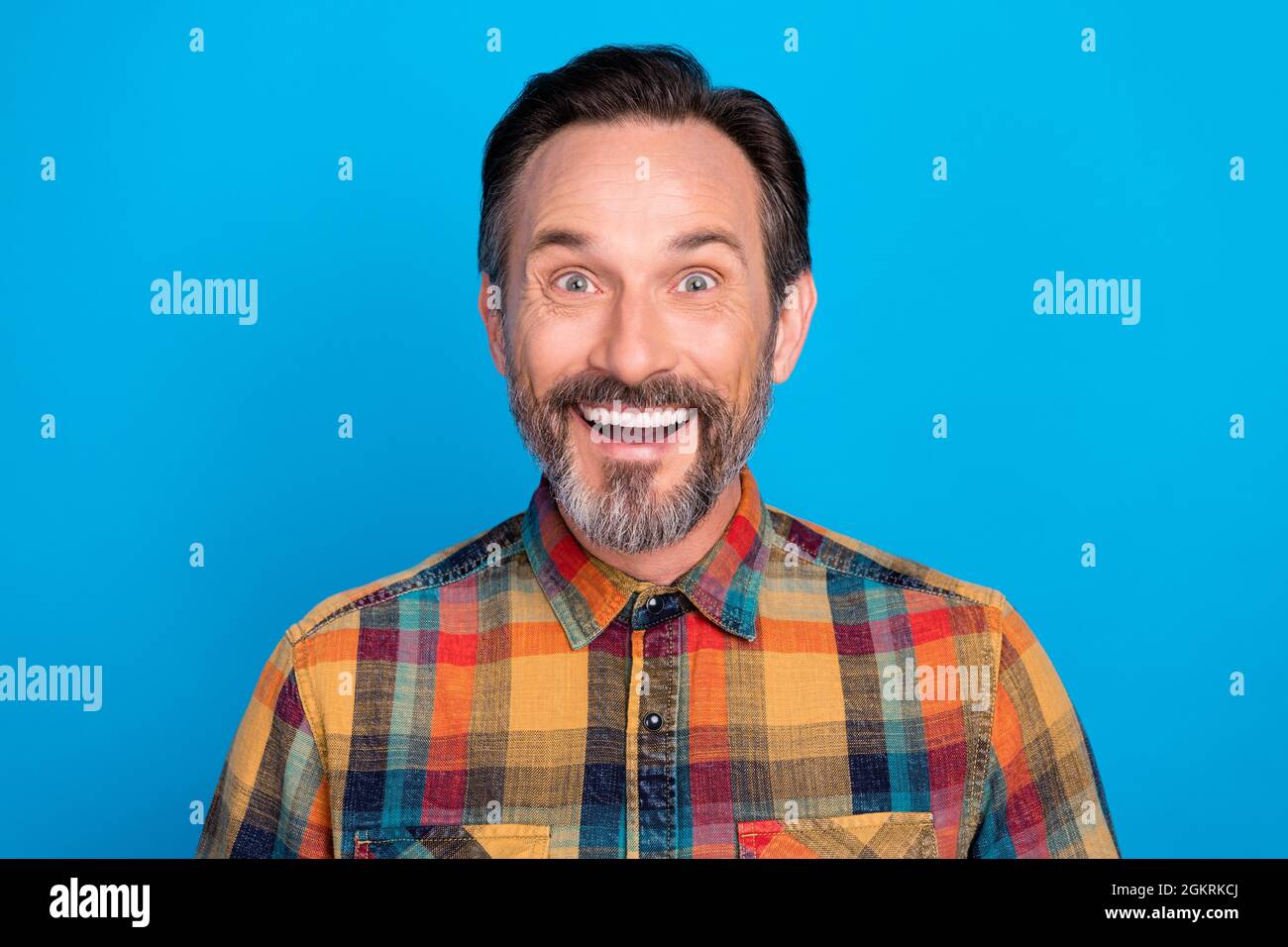 Photo portrait man staring amazed in plaid shirt smiling happy isolated ...
