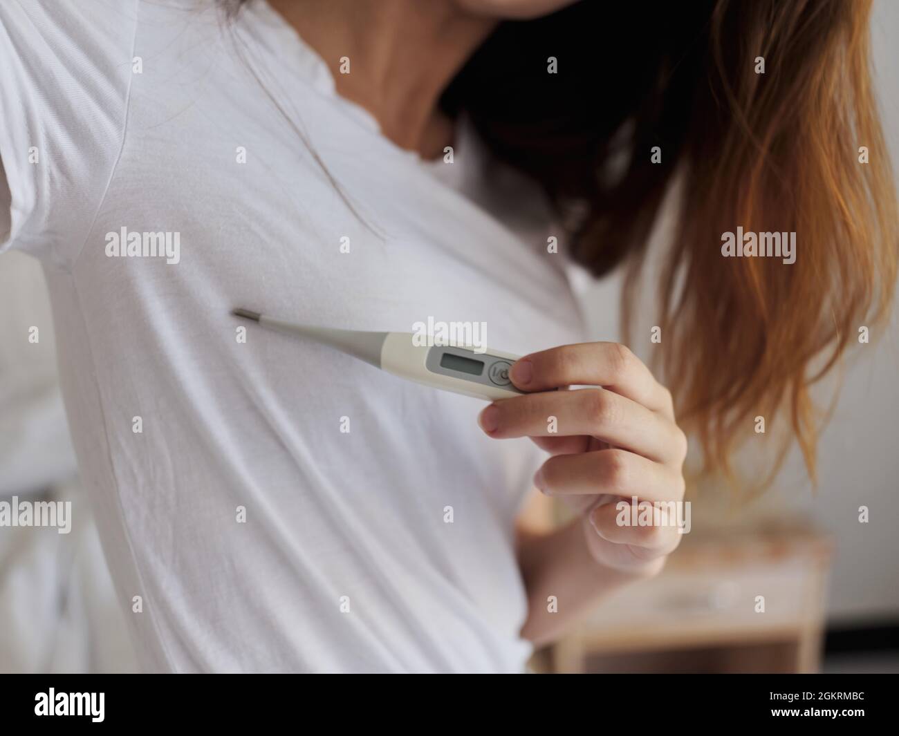 joyful woman hands checking armpit temperature Stock Photo - Alamy