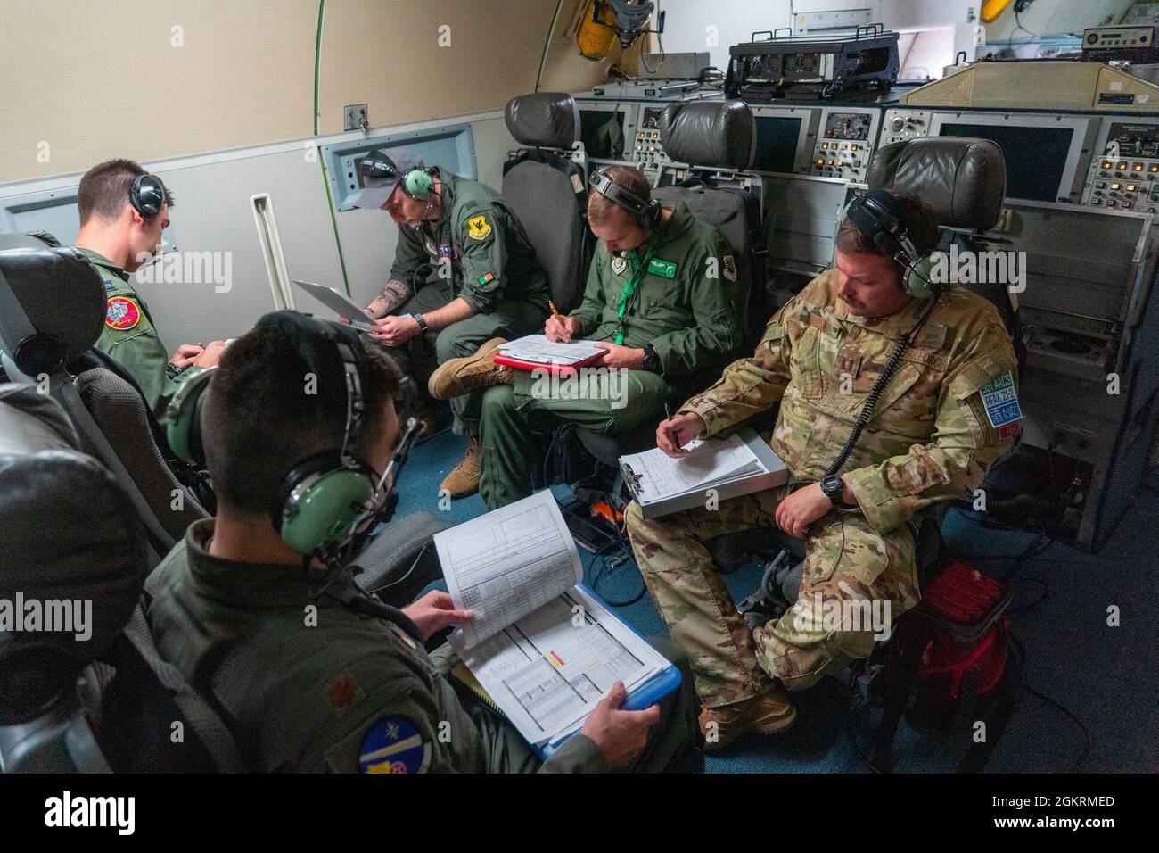 U.S. Air Force officers perform a debrief after a successful mission on the E-3 Sentry Airborne ...