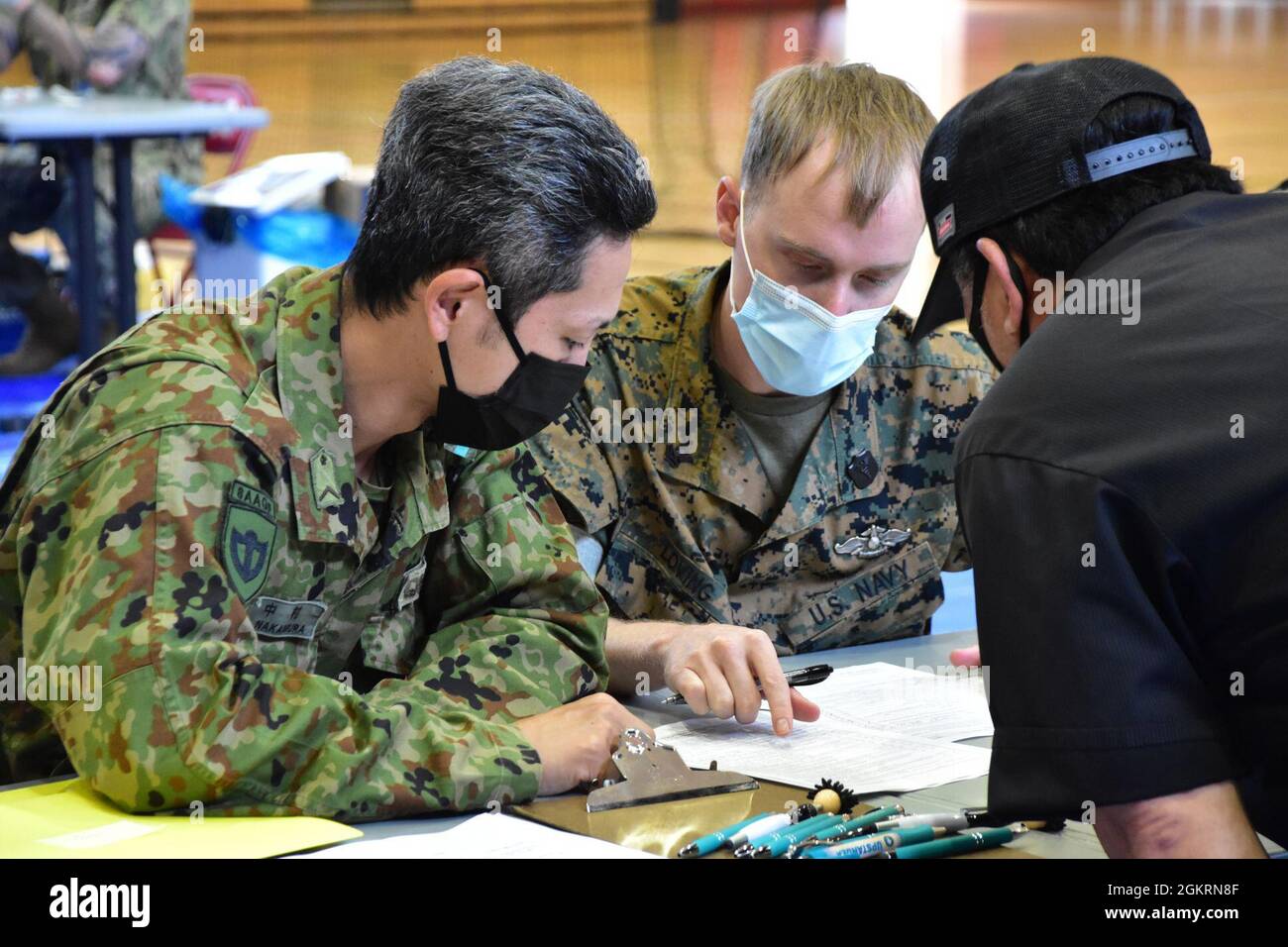 U.S. Navy HM2 Jason Loving, center, a 2d Battalion, 2d Marine Regiment ...