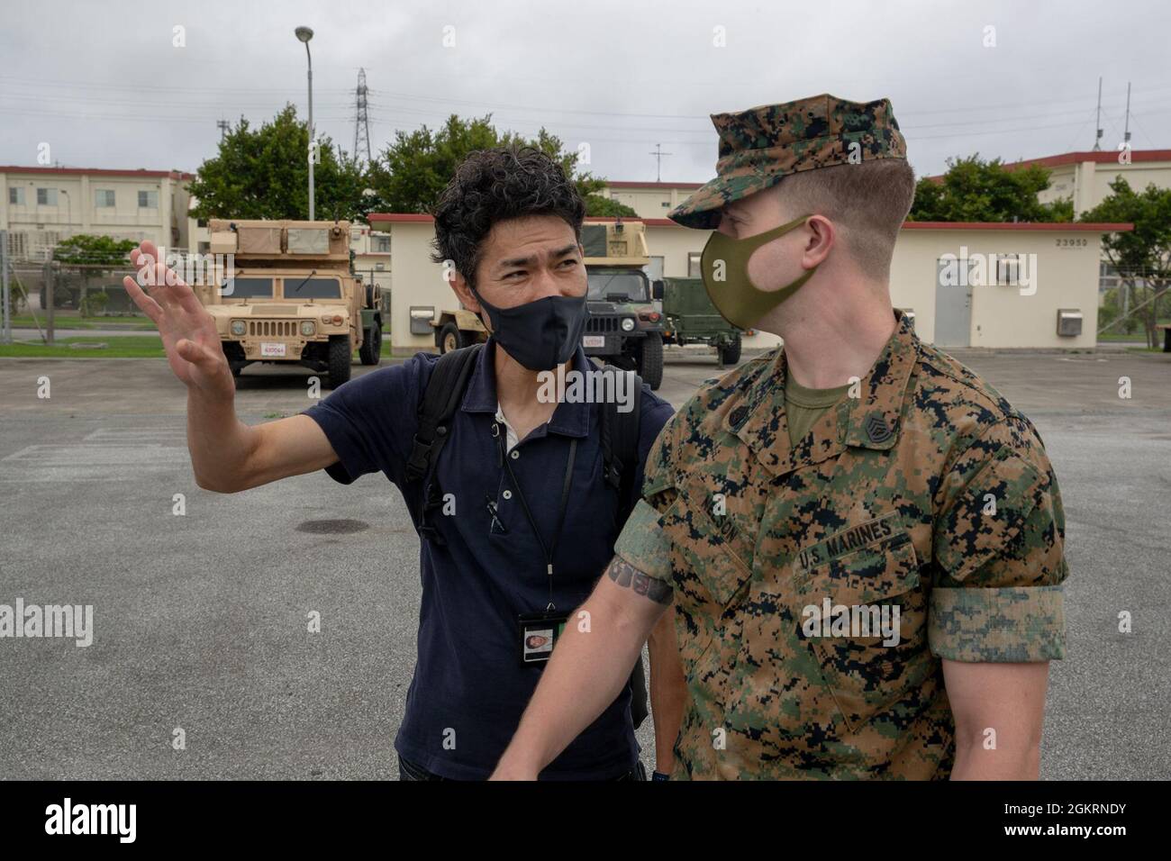A Japanese government official and a U.S. Marine discuss the M142 High ...