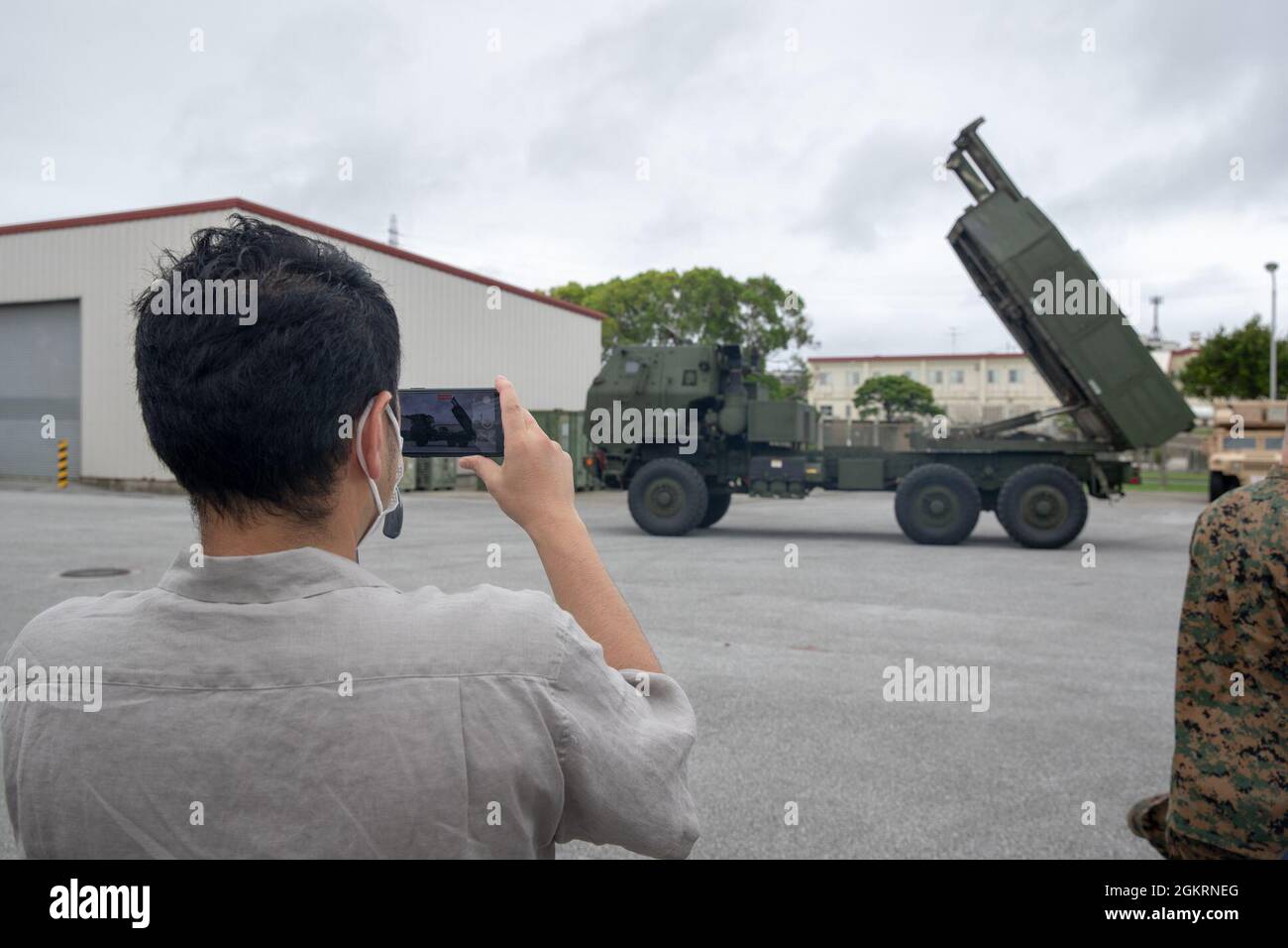 A Japanese government official takes photos of the M142 High Mobility ...