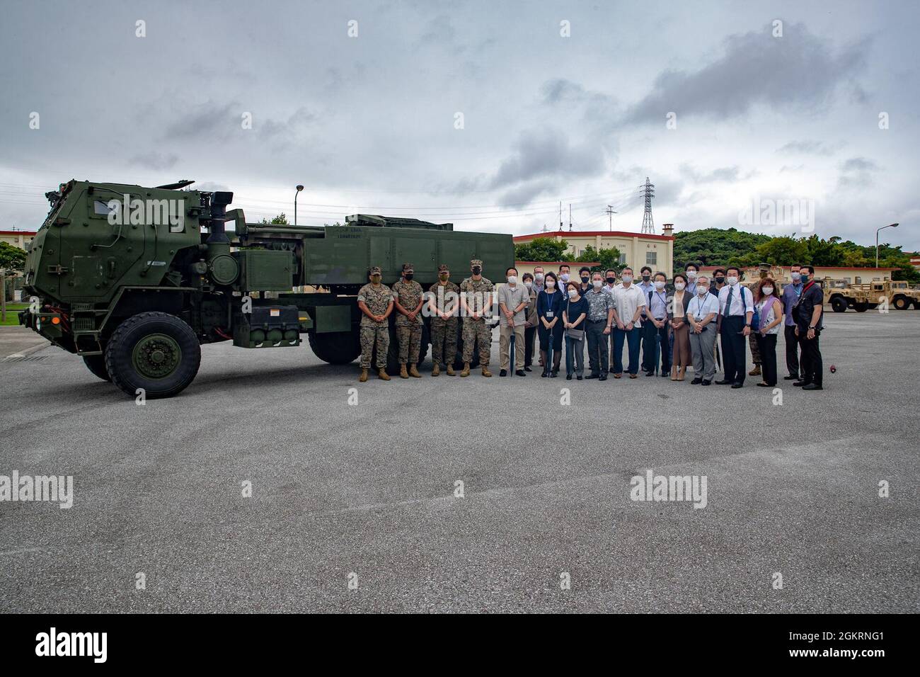 Japanese government officials and U.S. Marines pose for a photo in ...