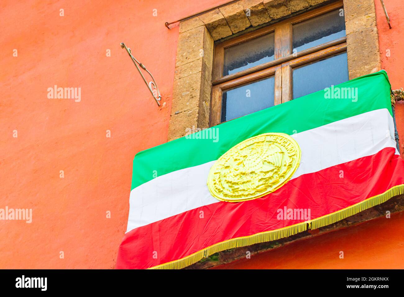Mexican flag green white red hanging on building in the center of ...