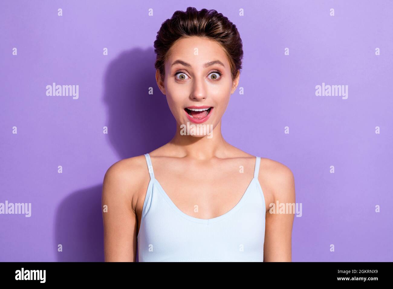 Photo portrait girl in blue top smiling staring amazed isolated pastel ...