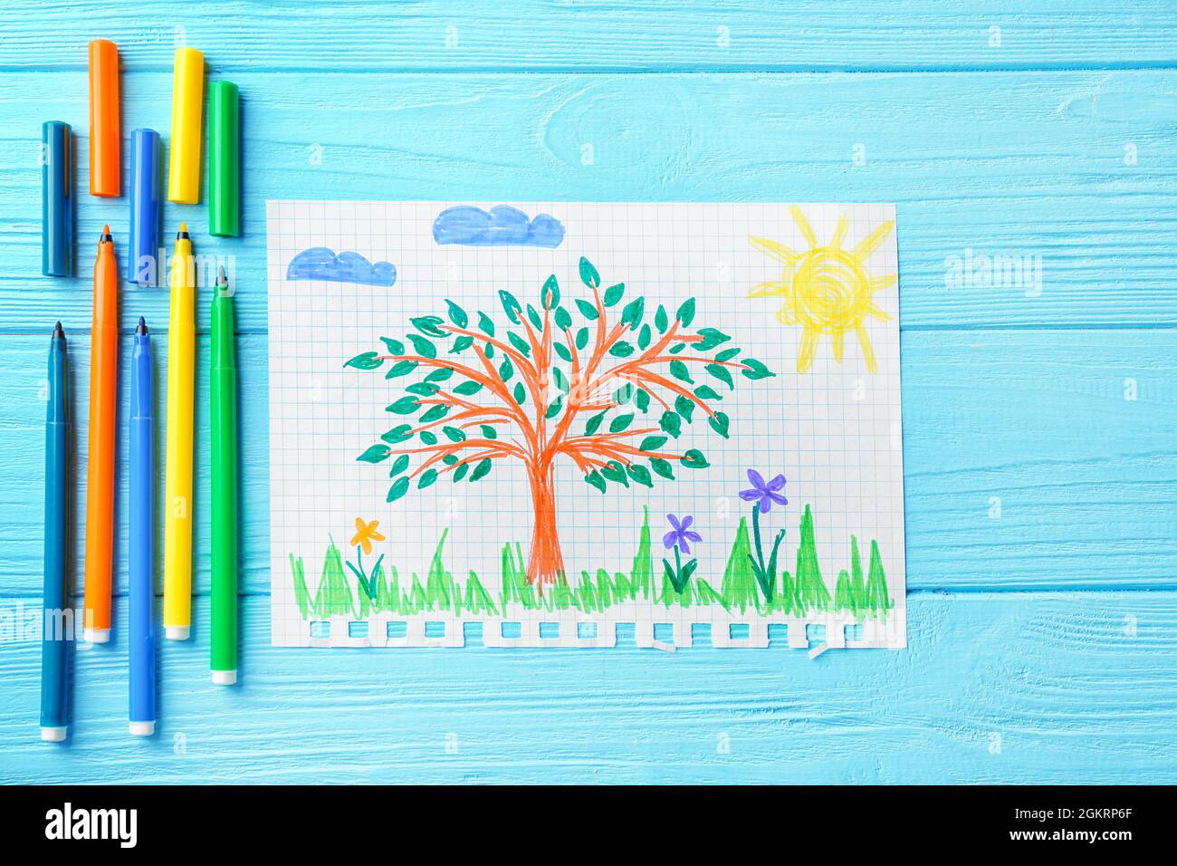 Child's drawing of tree on blue background Stock Photo - Alamy