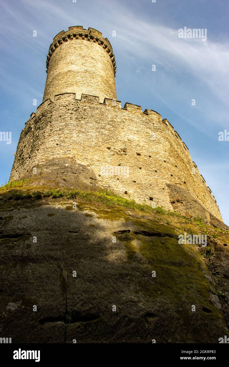 A circular stone tower behind the walls with the battlements of a ...