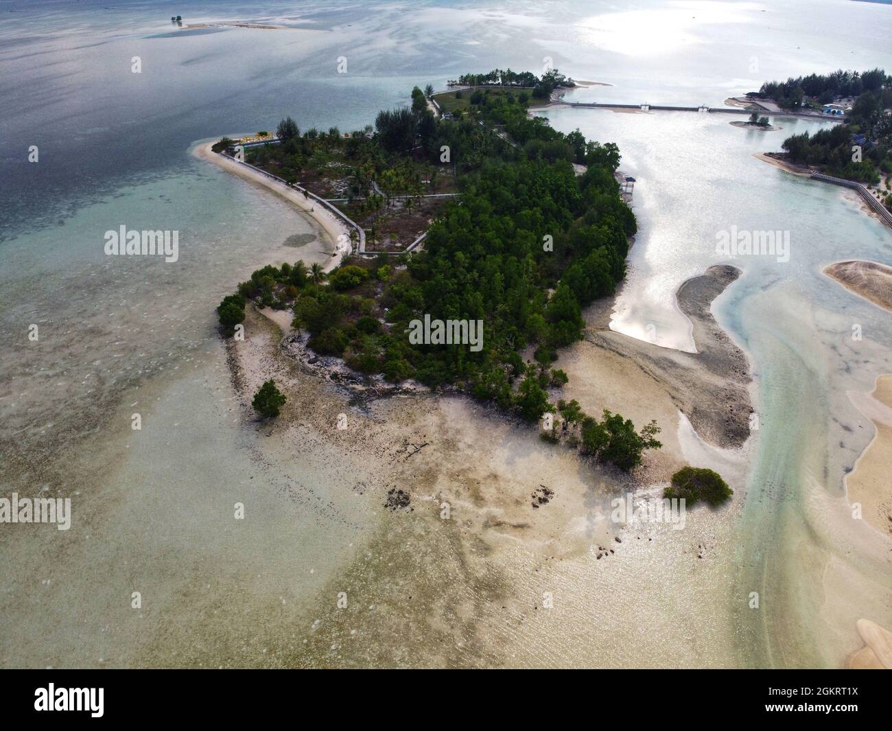 Aerial shot of islands with sand and green dense trees on clear water ...