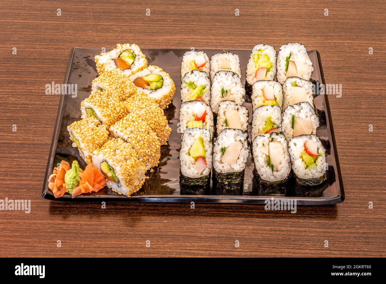 Assorted sushi tray with uramaki dragon roll stuffed with avocado ...