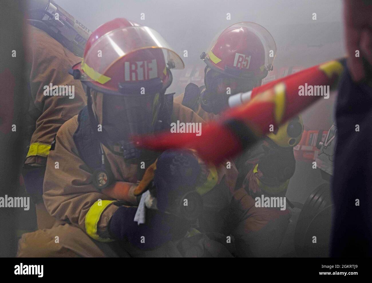 YOKOSUKA, Japan (June 23, 2021) – Members of the hose team combats a ...