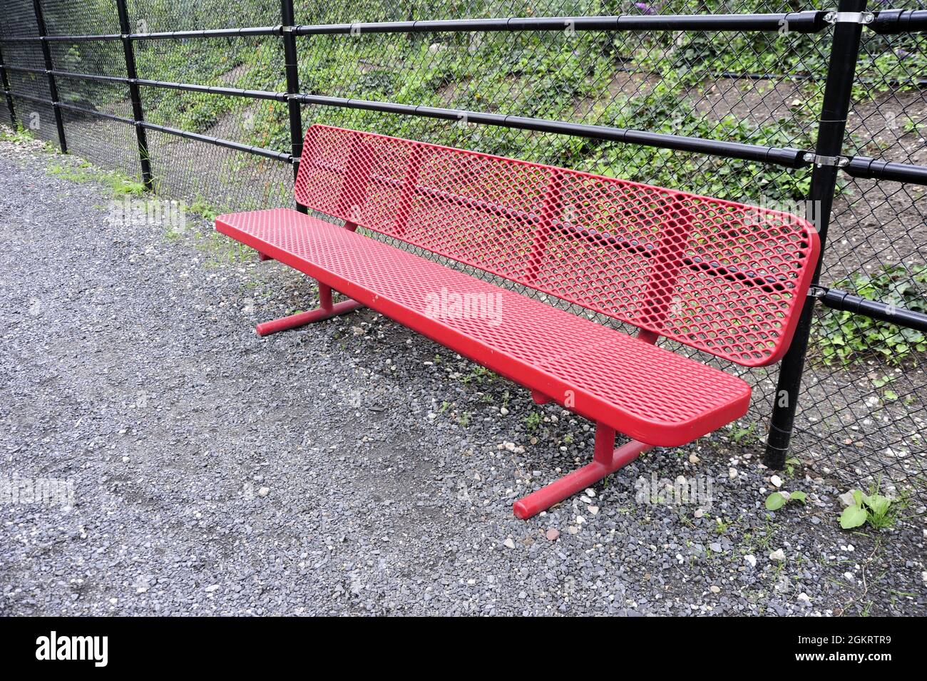 Red metal bench in the park Stock Photo - Alamy