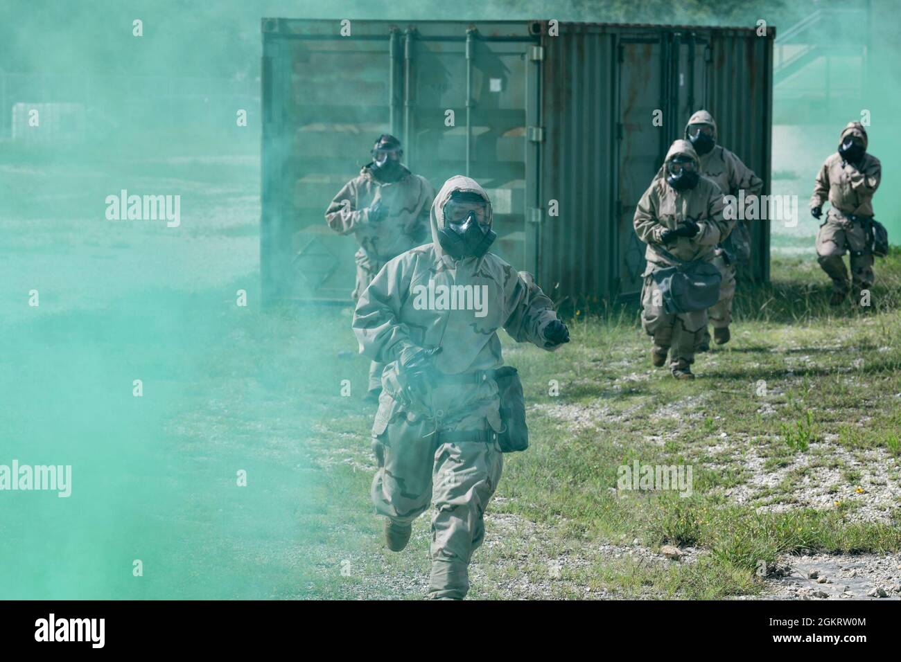 Test players wearing Level 4 MOPP gear advance to treat simulated ...