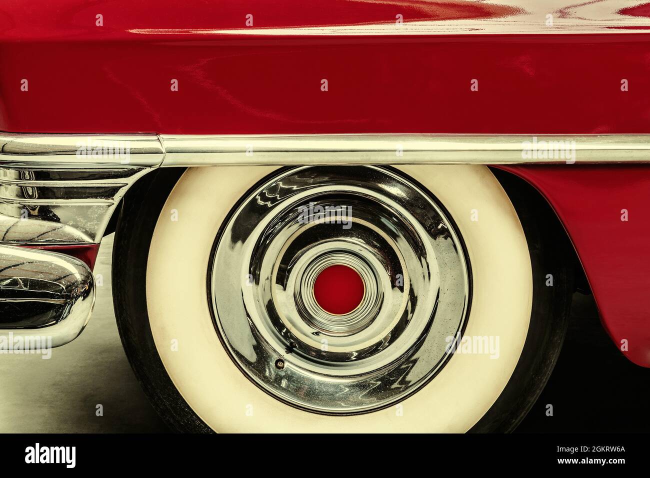 Retro styled image of the wheel of a red vintage American car Stock ...