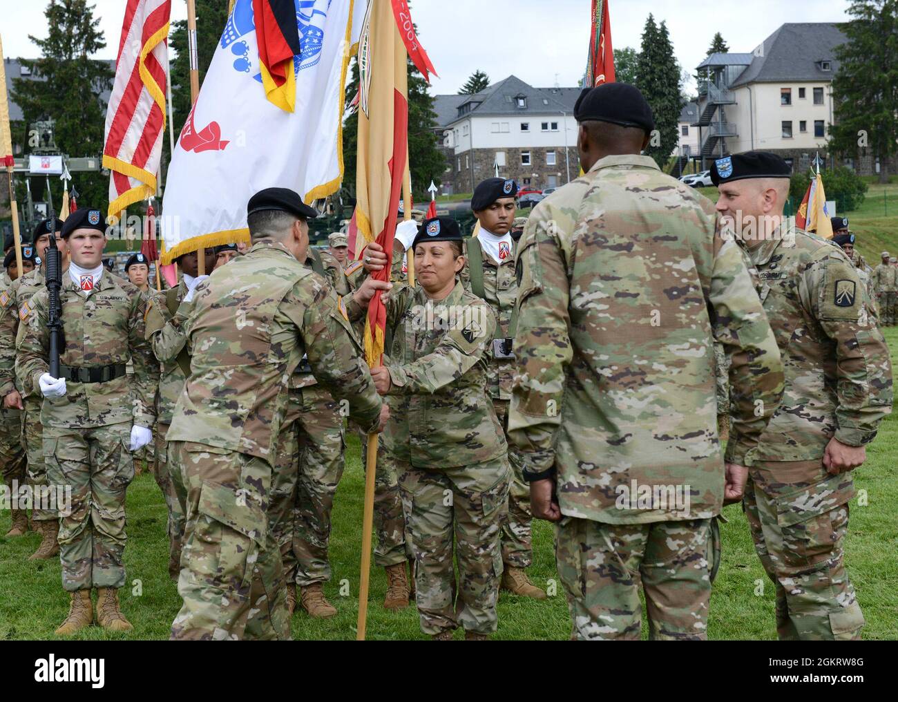 U.S. Army Col. Angel R. Estrada, commander passes the unit colors to ...