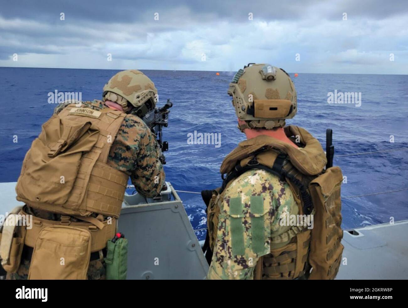 U.S. Marines with 4th Marines, 3d Marine Division conduct a crew-served ...