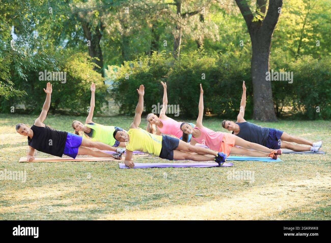 Group of young people doing exercise outdoor Stock Photo - Alamy