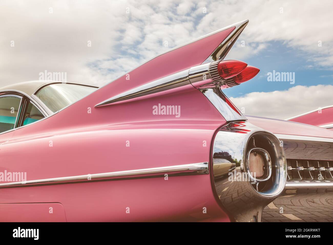 Retro styled image of the rear end of a pink classic car Stock Photo ...
