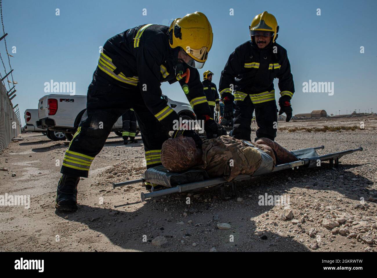 Qatar Emiri Air Force firefighters assess a patient during a simulated ...