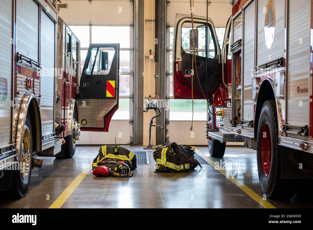 Bunker gear sits staged next to two fire trucks belonging to the 788th ...