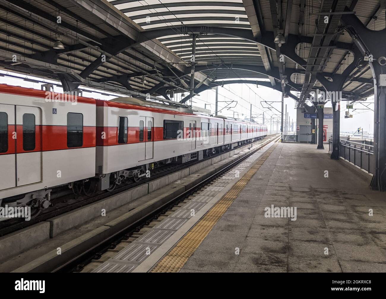 The electric train is leaving from the station to the suburbs area in ...