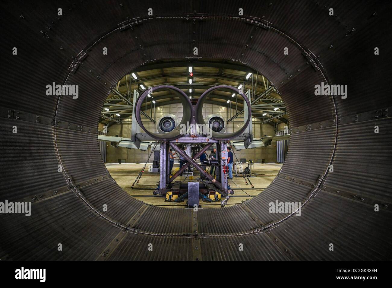 The engines of an A-10 Thunderbolt II can be seen from a "hush house ...