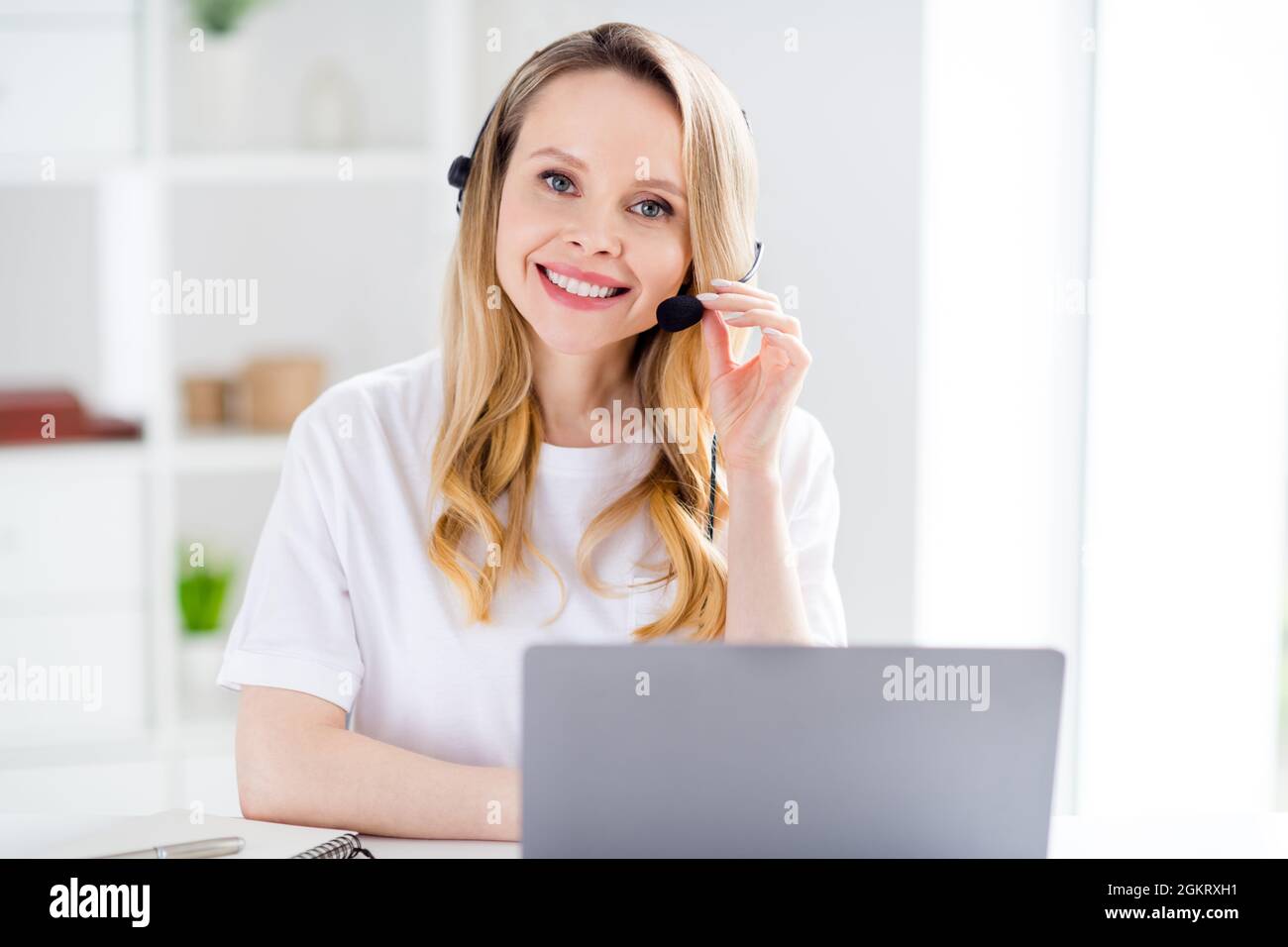 Photo of young attractive woman happy positive smile headphones agent call center work home help ...