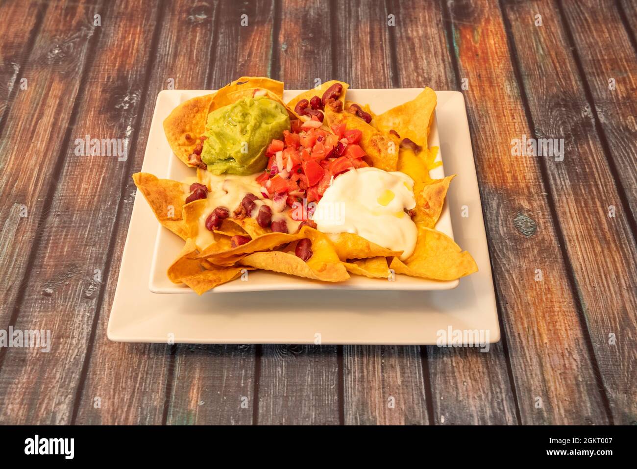 Farmers nachos with guacamole, pico de gallo, red beans and two types ...