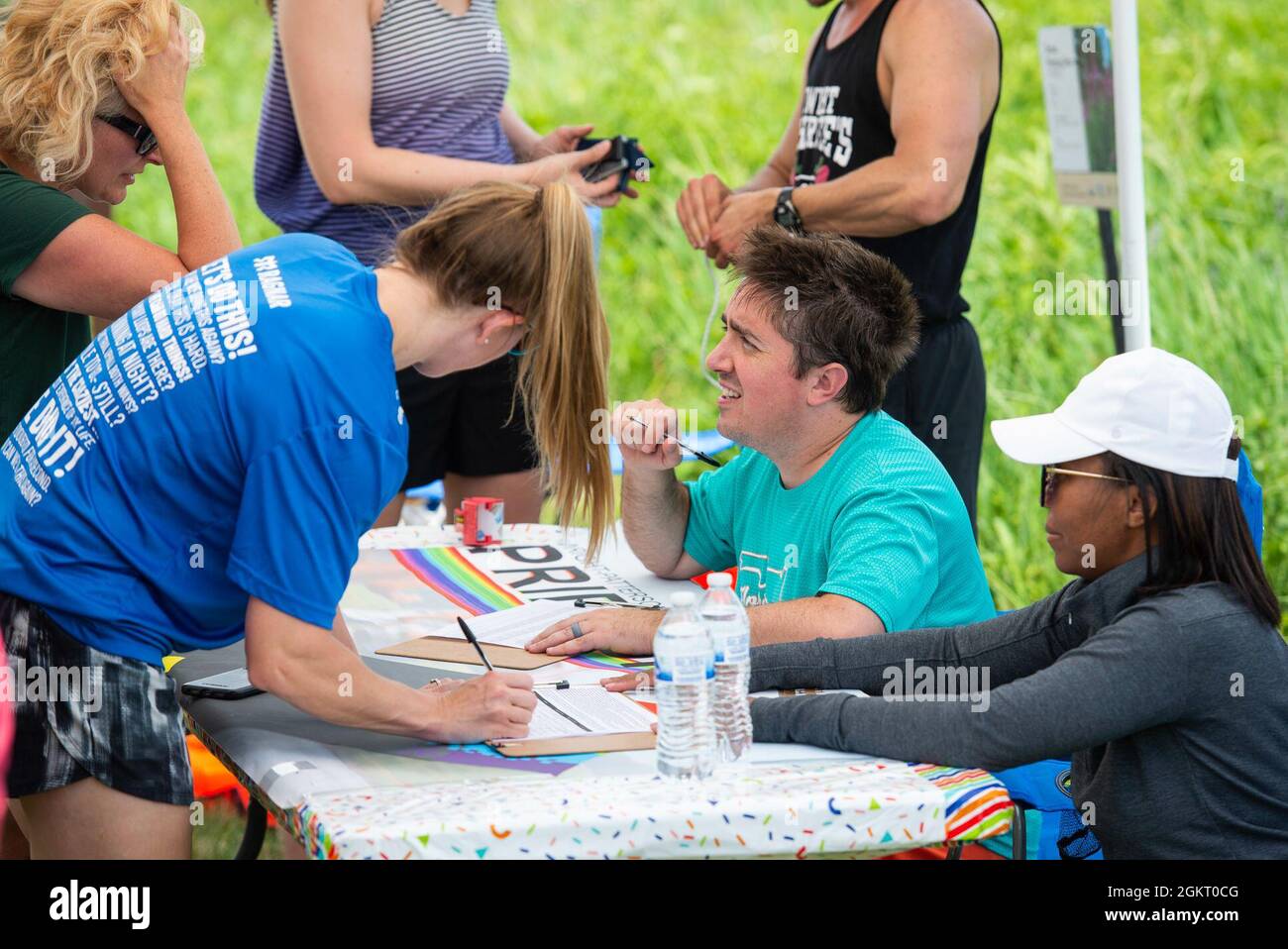 Runners register upon arrival to the Pride Month 5k run which takes ...