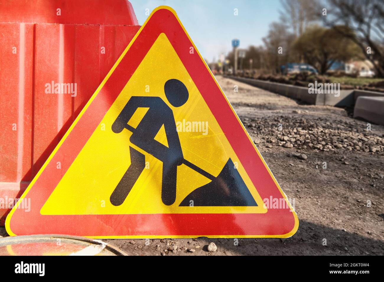 The warning sign for road repair work lies on the roadway Stock Photo ...